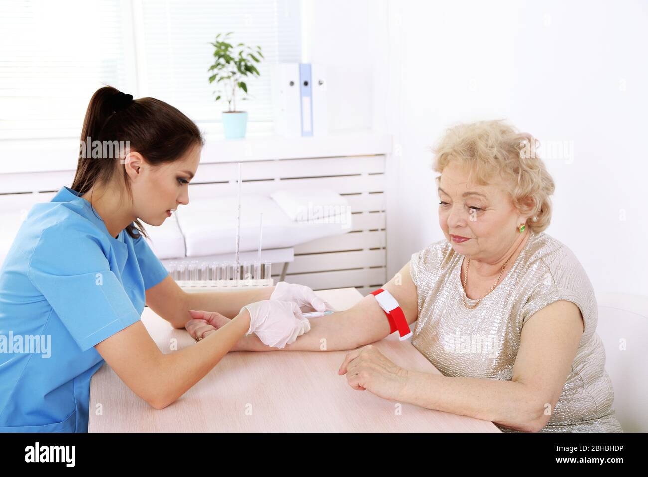 Nurse with syringe is taking blood for test in hospital Stock Photo - Alamy