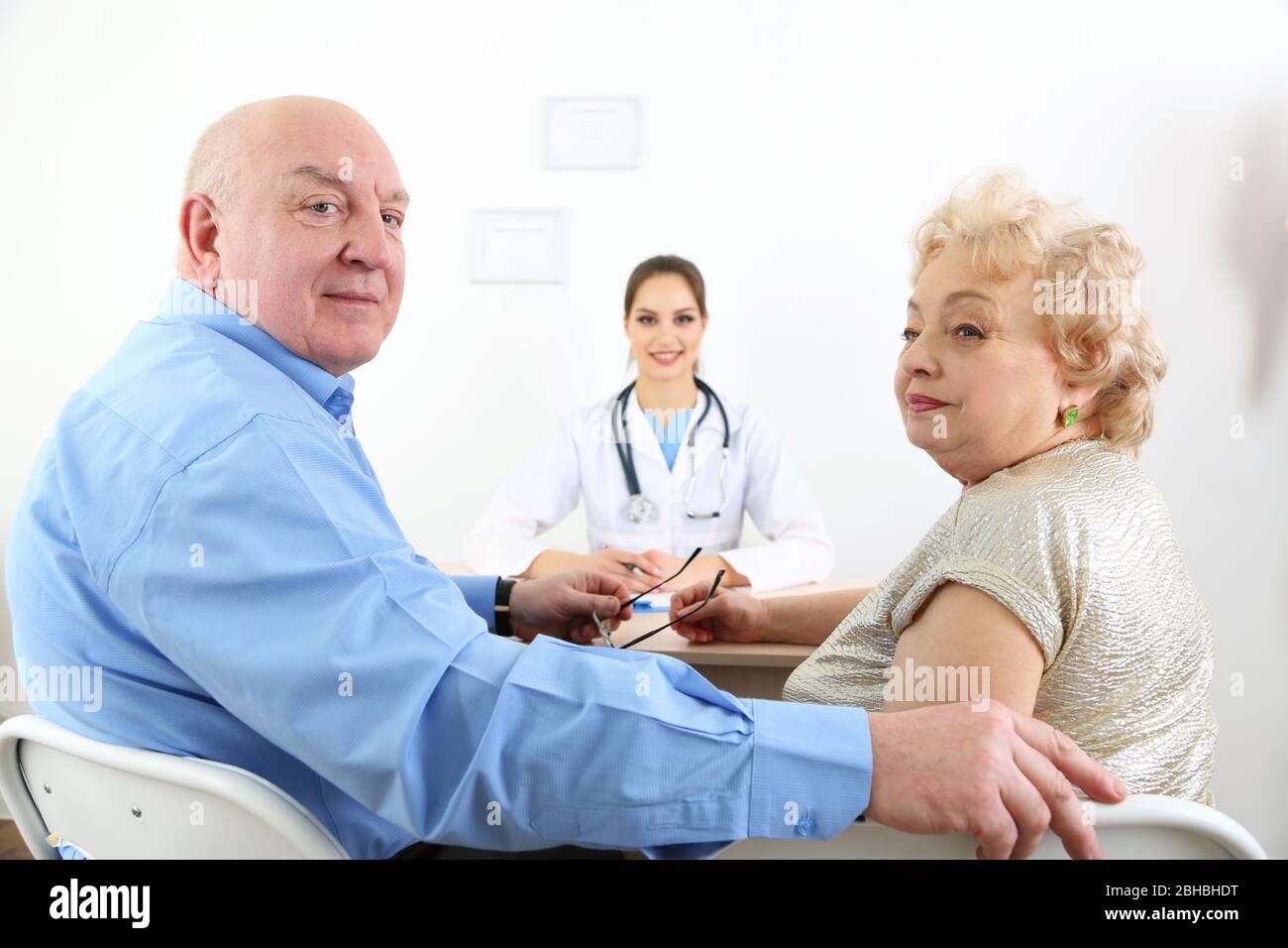 Happy doctor and patients in hospital clinic Stock Photo - Alamy
