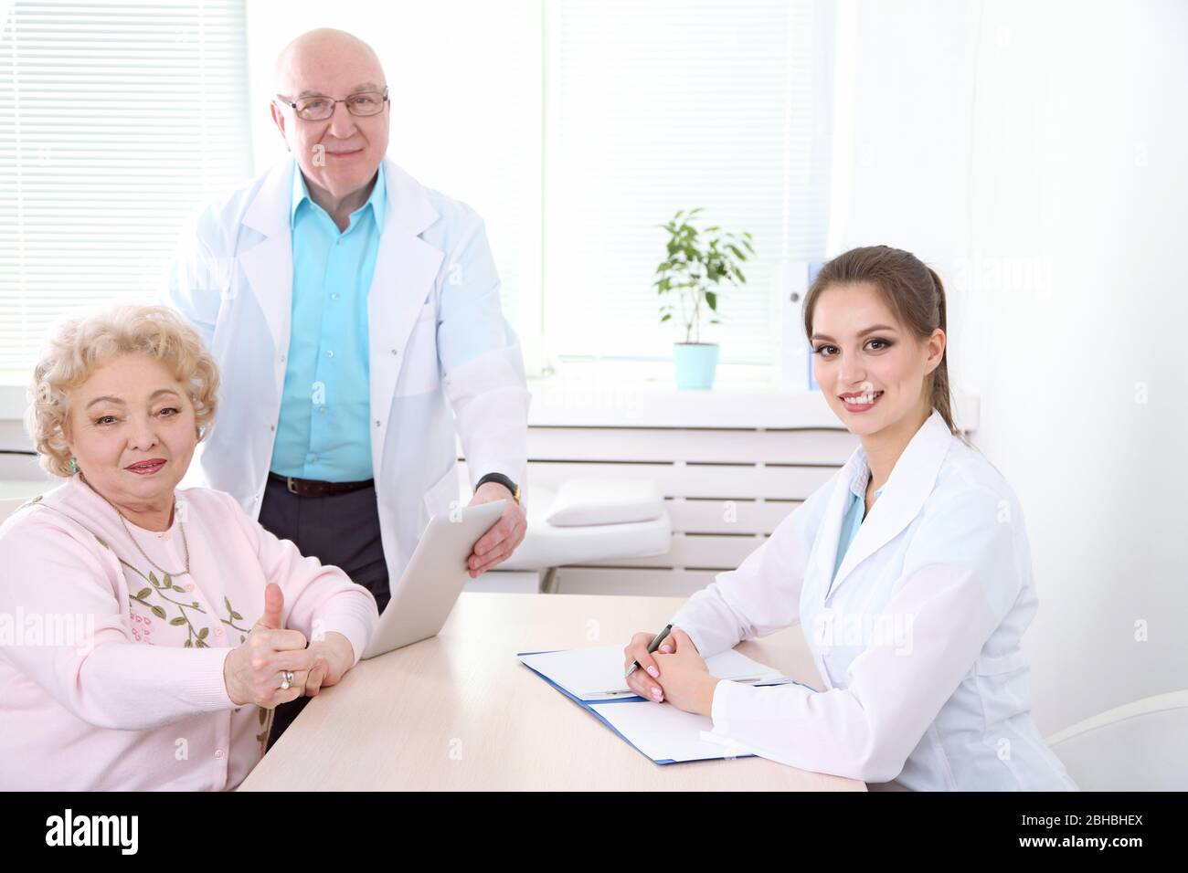 Happy doctors and patients in hospital clinic Stock Photo - Alamy