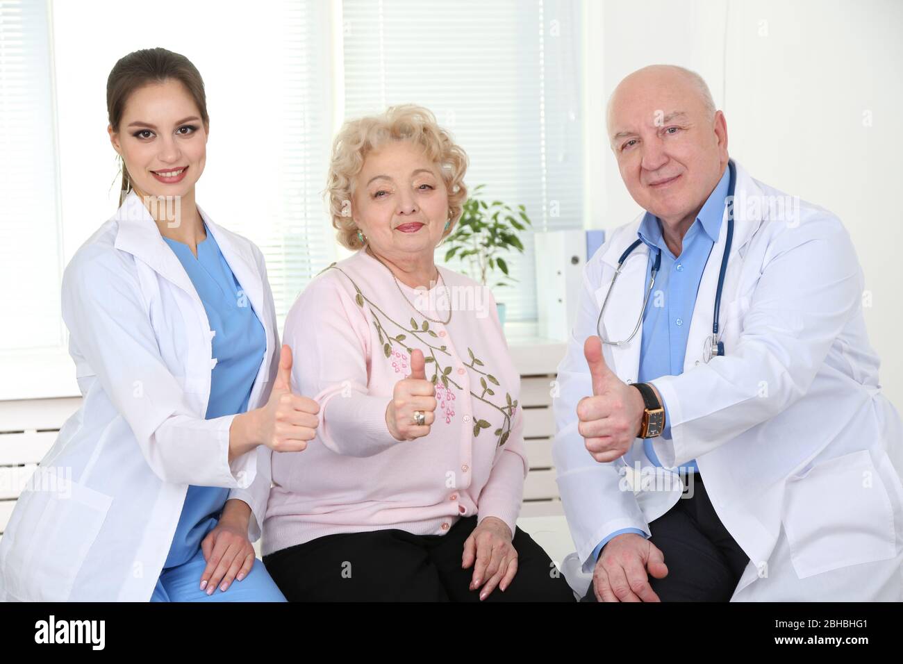 Happy doctors and patients in hospital clinic Stock Photo - Alamy