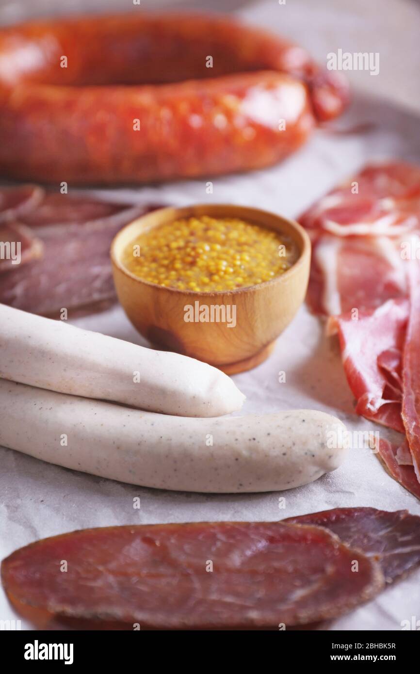 Assortment of deli meats on parchment background Stock Photo - Alamy