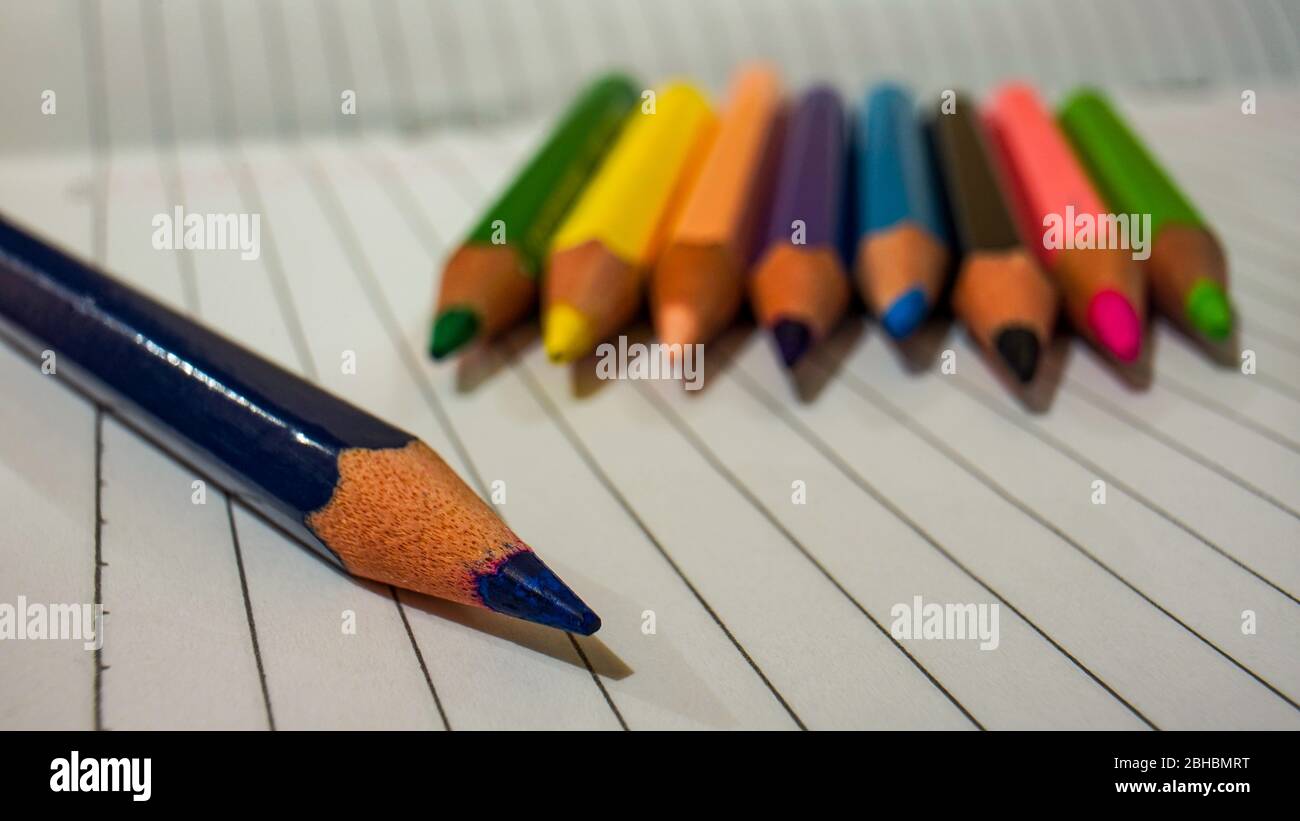 Close up of some colored pencils placed on top of the notebook Stock ...