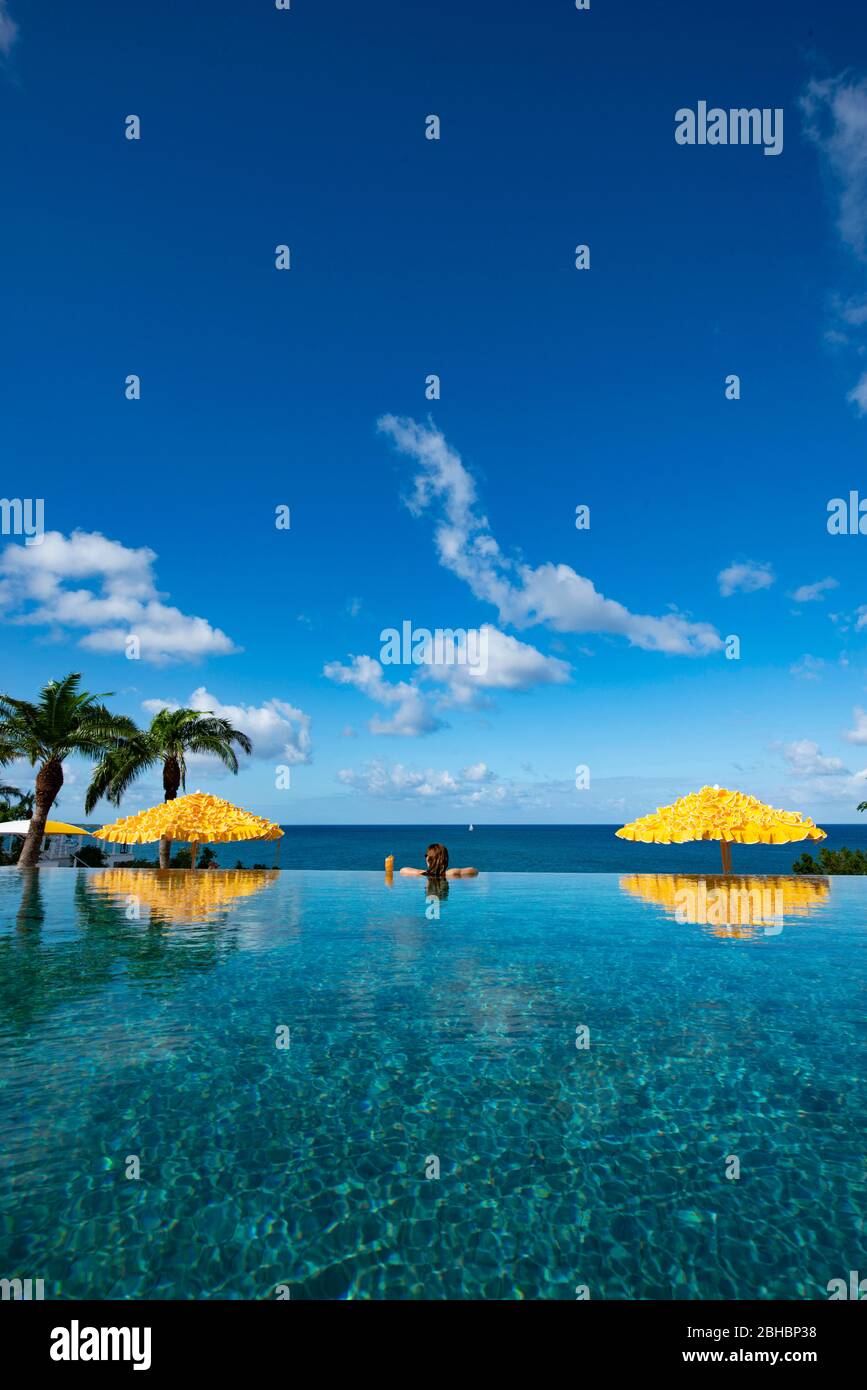The Caribbean, Anguilla. Woman in the pool at Malliouhana Hotel Stock ...