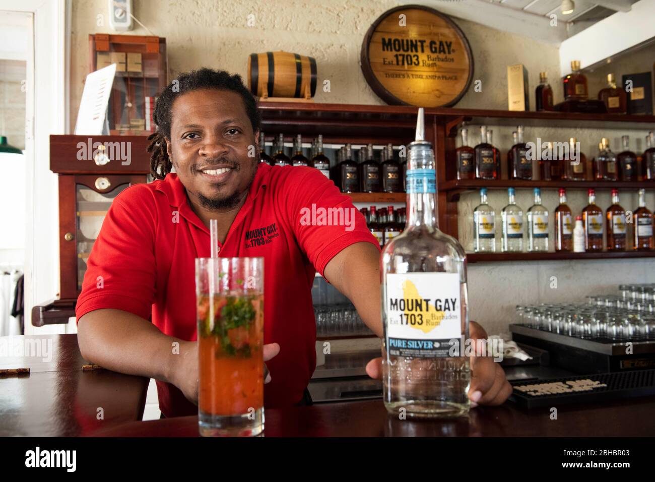Caribbean, Barbados, Gay Rum factory. Man serving rum Stock Photo - Alamy