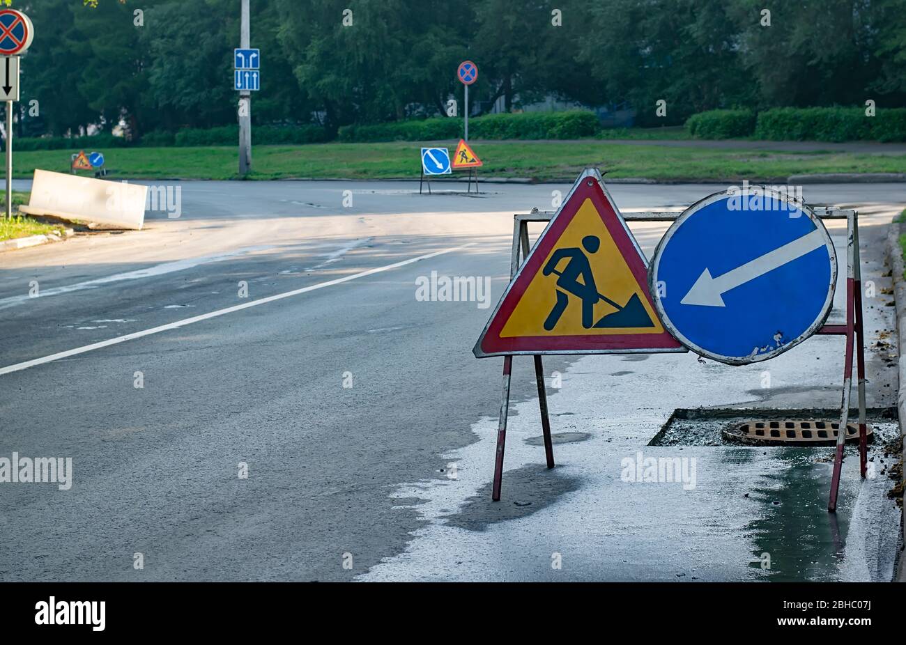 view of several road signs stop, detour, road repairs on a section of ...