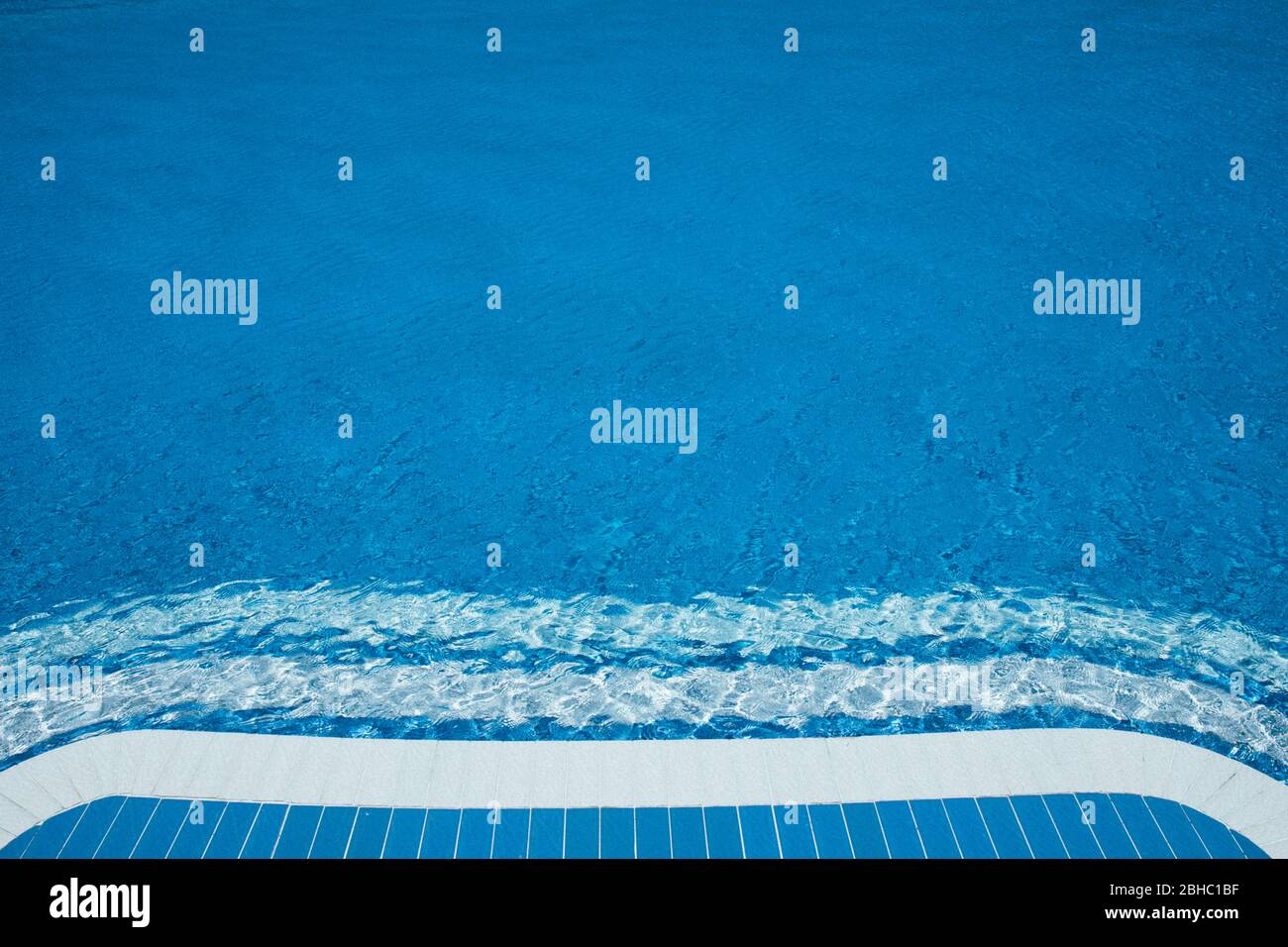 Steps to the pool, blue clear water in the outdoor swimming pool, safe ...