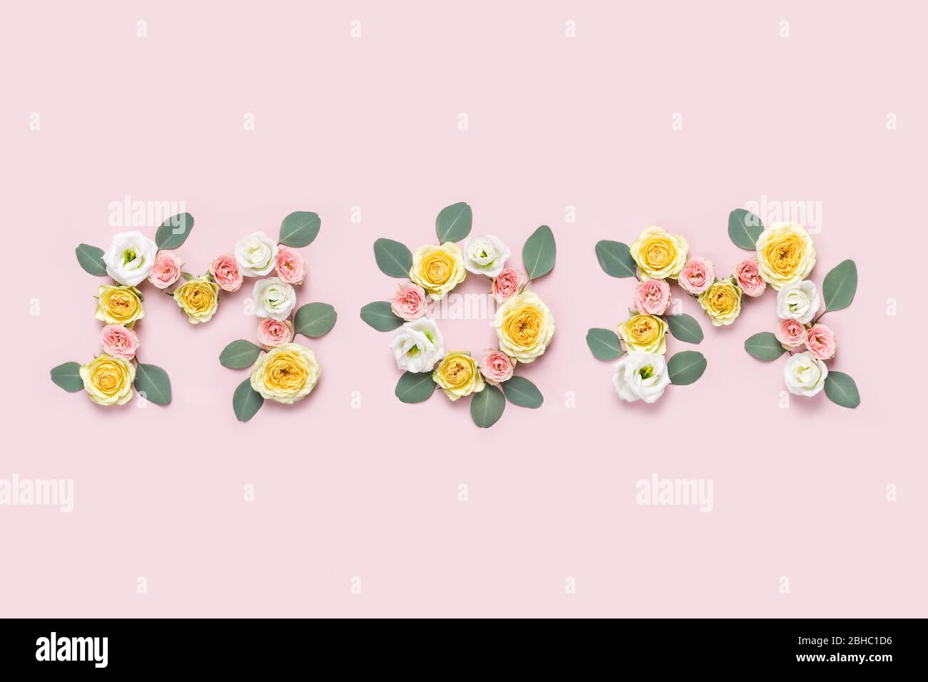Mom word is made of beautiful roses flowers and eucalyptus leaves on ...
