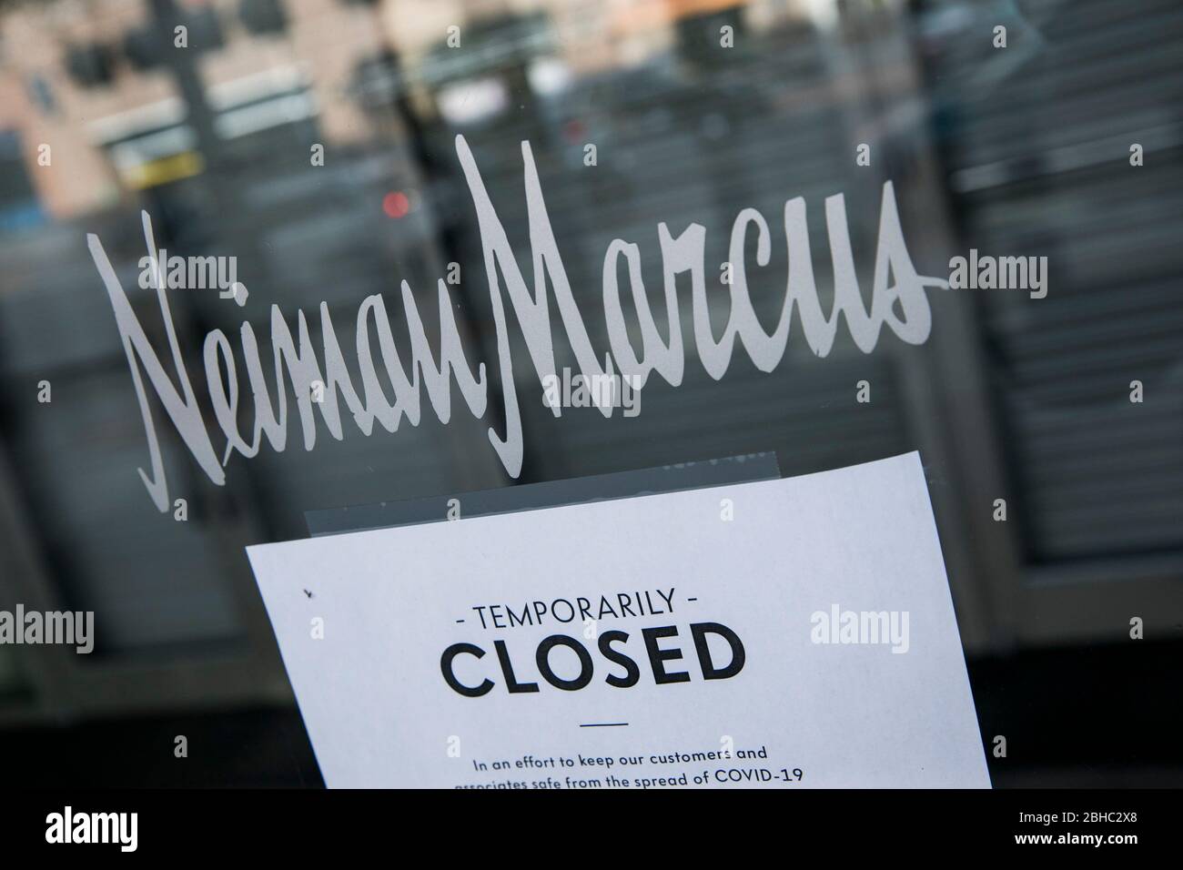 A sign informing customers a Neiman Marcus retail store is closed in ...