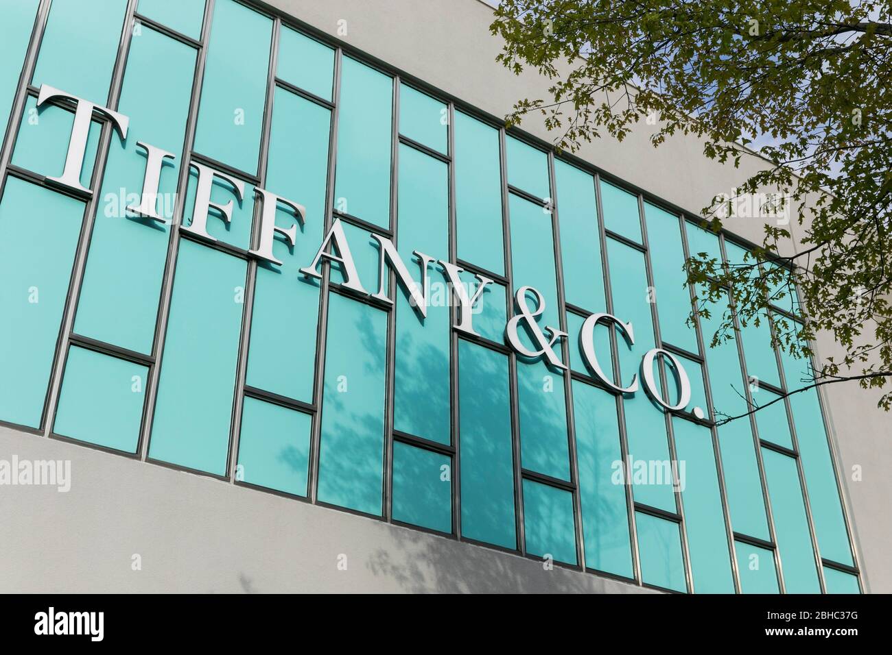 A logo sign outside of a Tiffany & Co., retail store location in ...