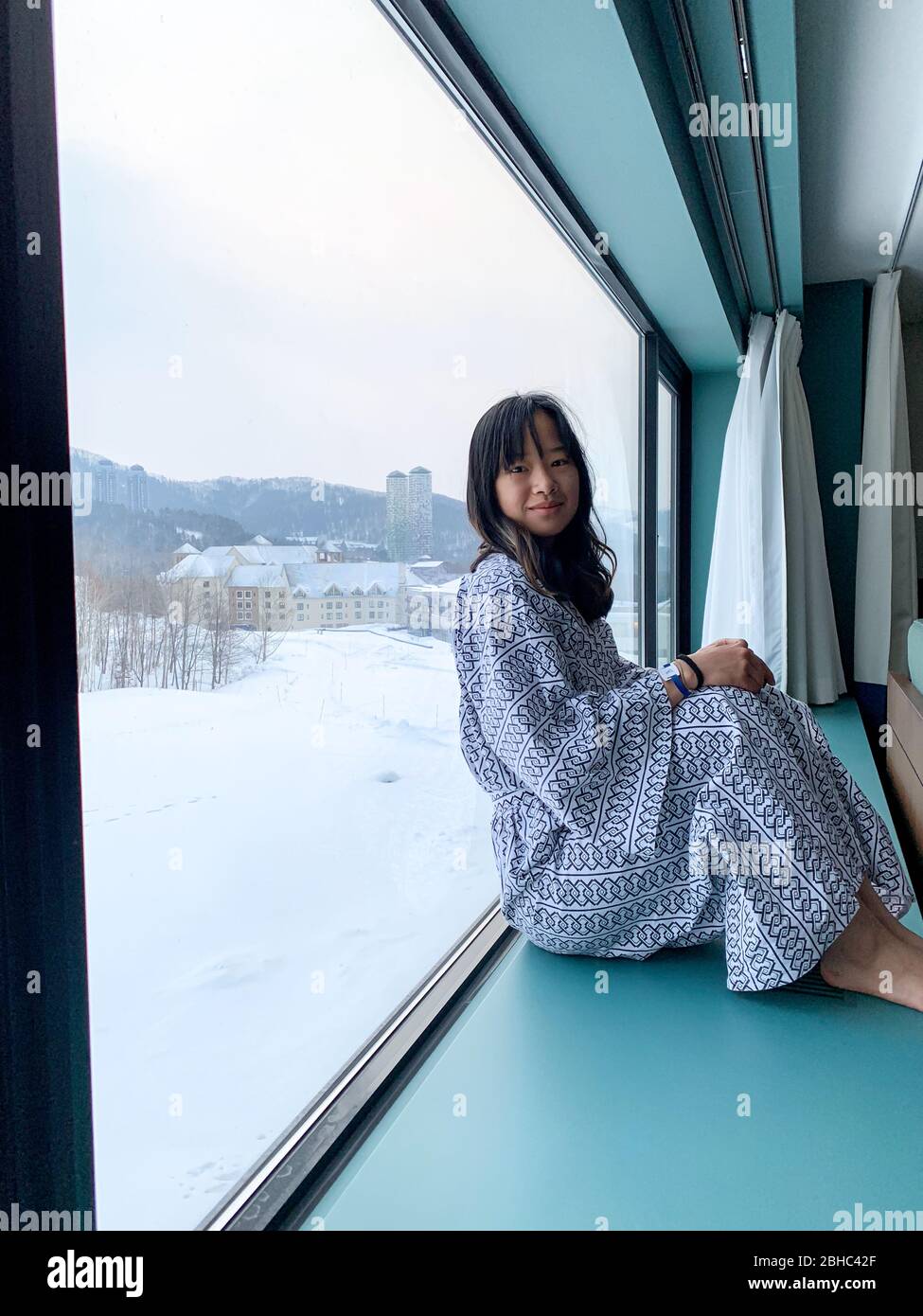 Woman in a traditional japanese pajama (jinbei) with view of snow cap ...