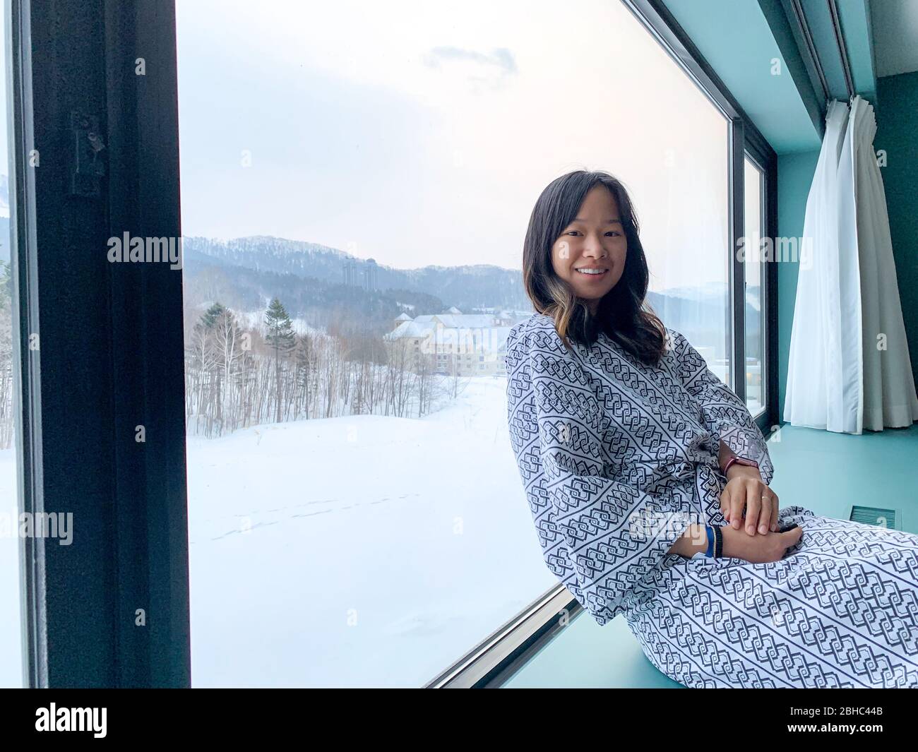 Woman in a traditional japanese pajama (jinbei) with view of snow cap ...