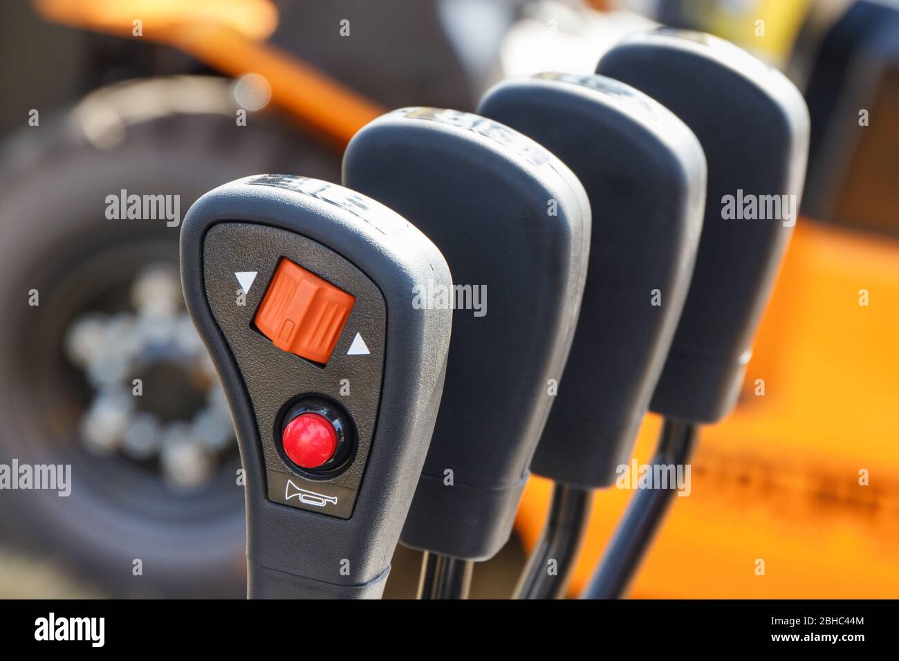Operating control levers with buttons in loader machine or other ...