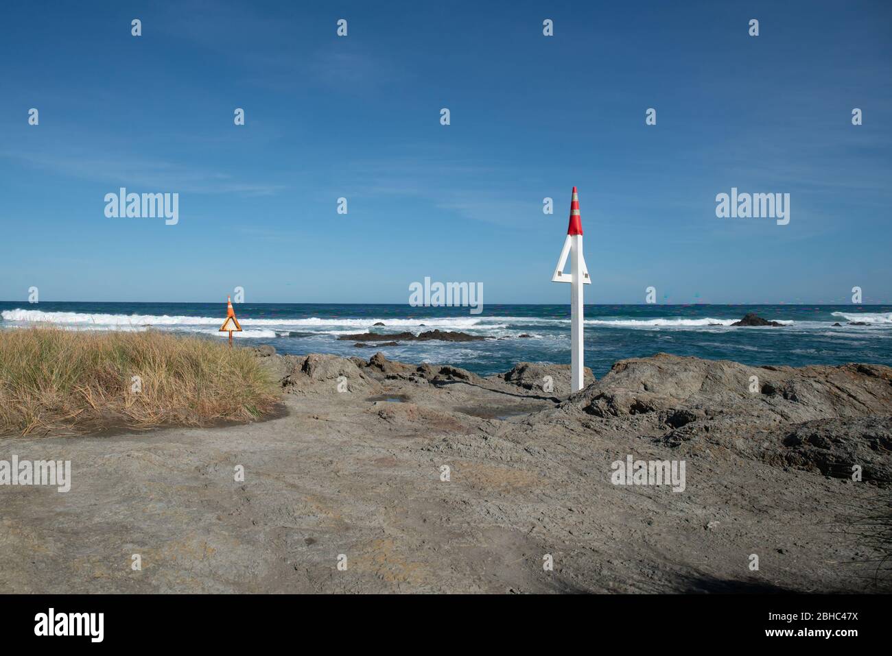 Two Maritime sign posts embedded in the coast rock warning sea vessels ...