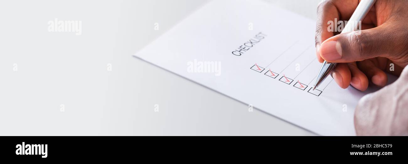 African American Hand Filling Form And Checklist Stock Photo - Alamy