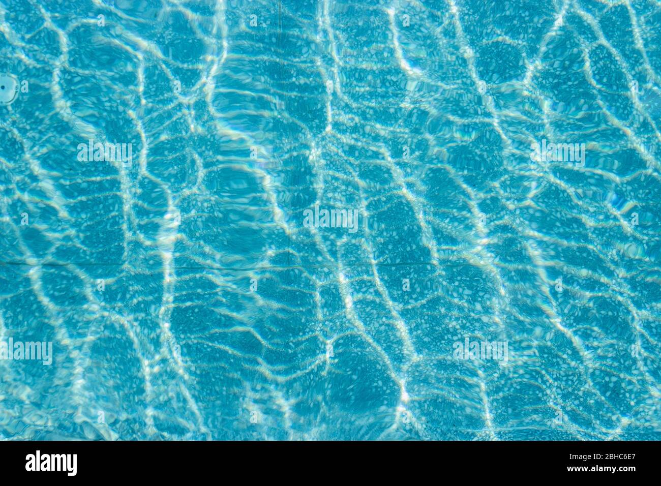 Abstract top view blue ripple swimming pool water and sun reflection ...