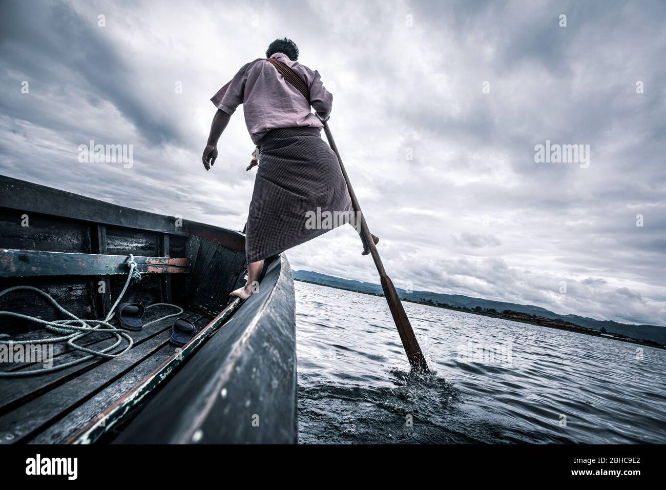 Local fishermen practicing a distinctive rowing style which involves ...