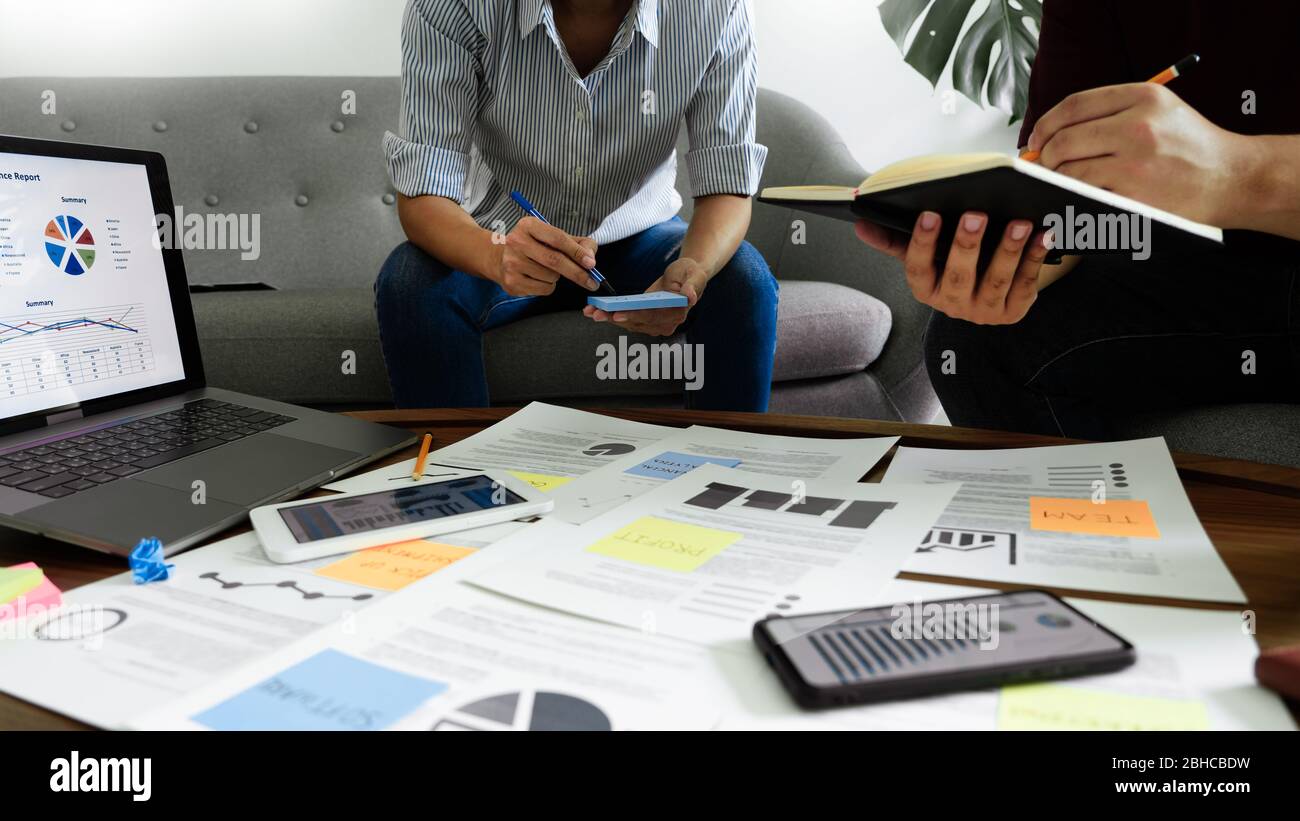 Business people writing on sticky notes for colleagues thinking ...
