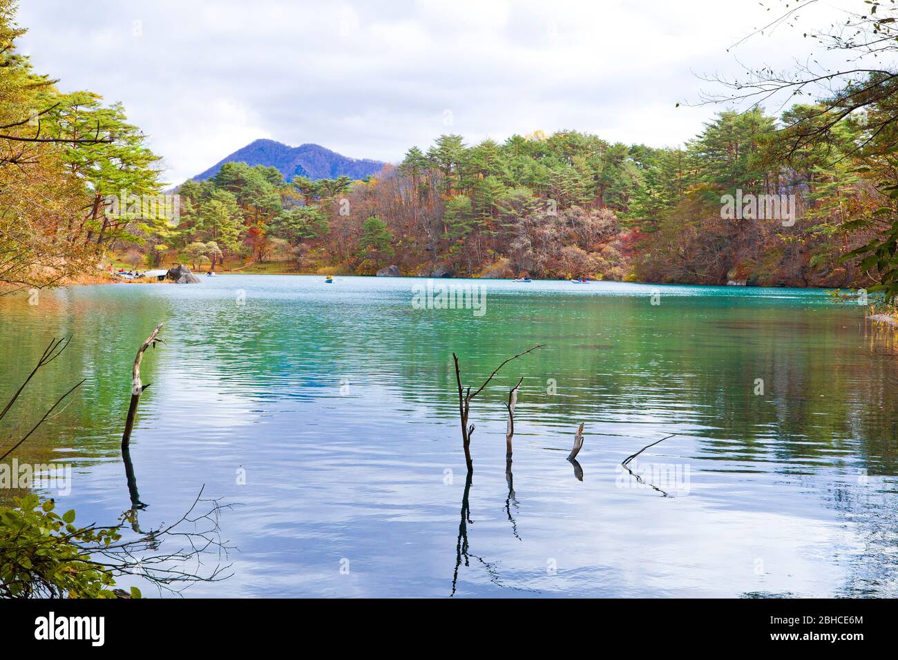 Tourists ride in a boat on a Goshikinuma (Five Colored Lakes) in ...