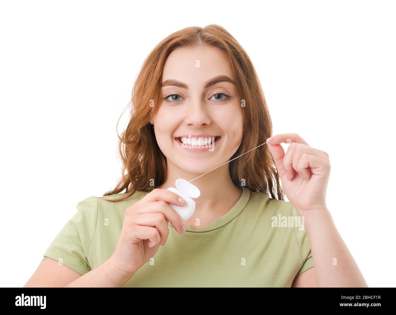 Beautiful young woman with dental floss on white background Stock Photo ...