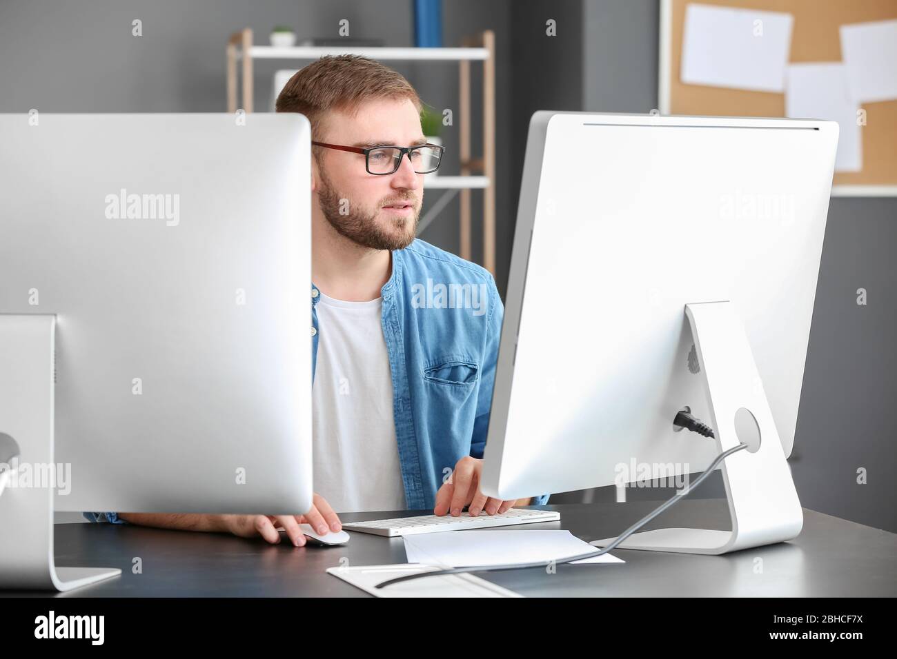 Male programmer working in office Stock Photo - Alamy