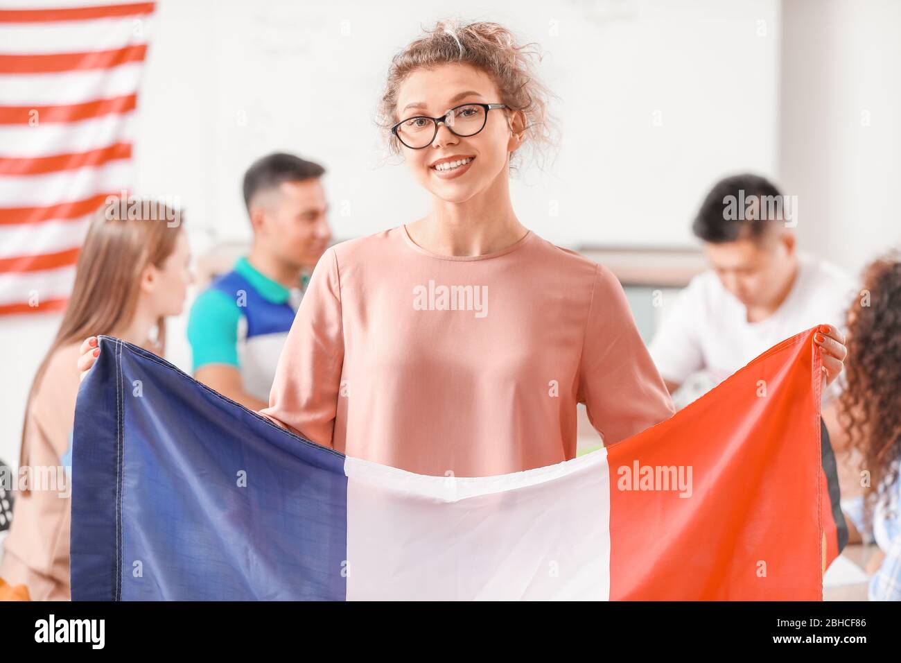 Female student with flag of France at language school Stock Photo - Alamy