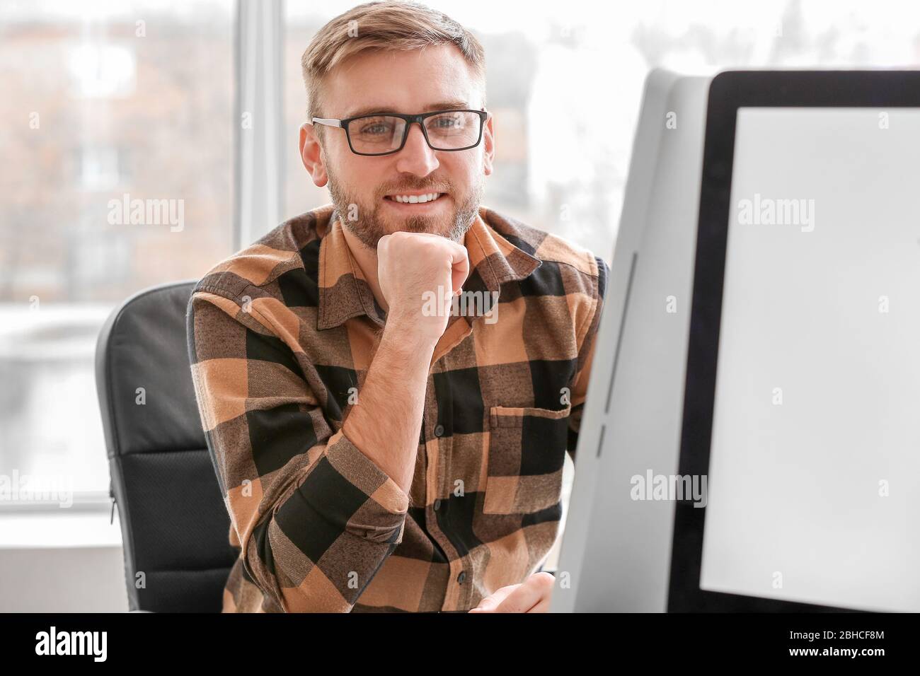 Male programmer working in office Stock Photo - Alamy