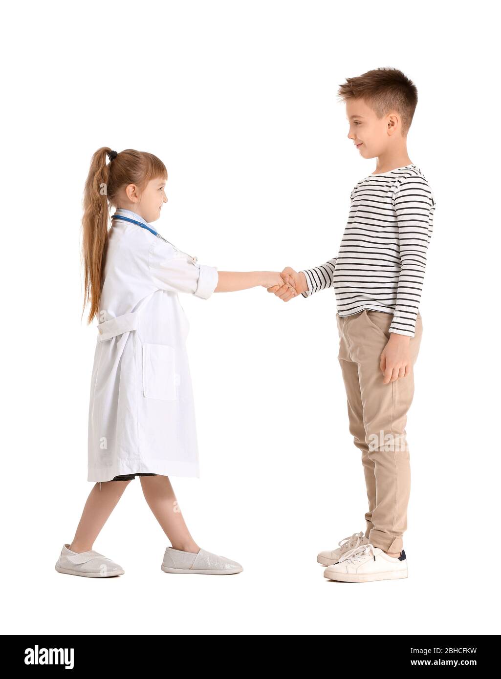 Cute little doctor with patient shaking hands on white background Stock ...