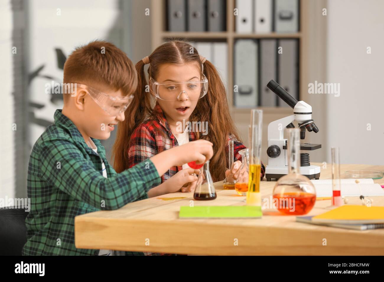 Cute little children at chemistry lesson in classroom Stock Photo - Alamy