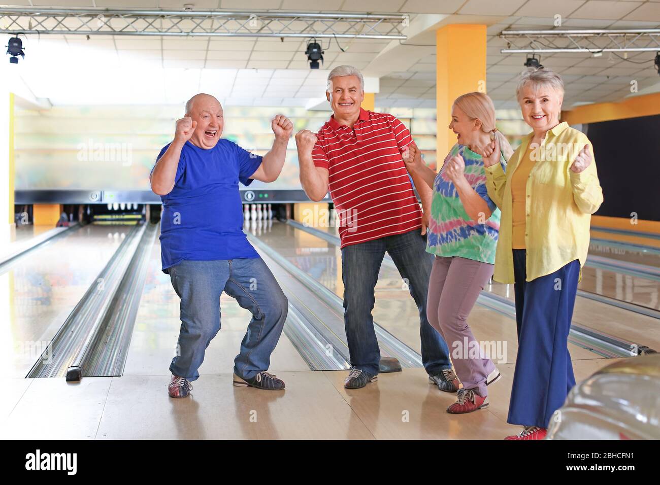 Senior people playing bowling in club Stock Photo - Alamy