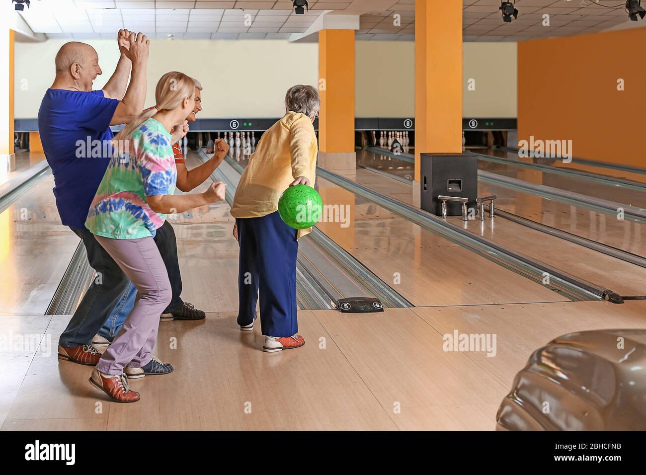 Senior people playing bowling in club Stock Photo - Alamy