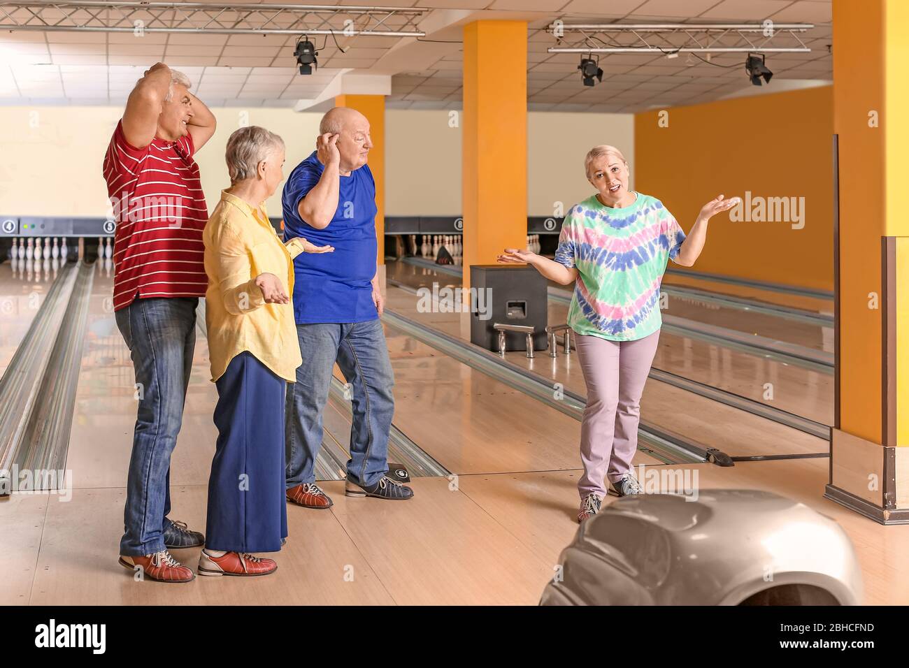 Senior people playing bowling in club Stock Photo - Alamy