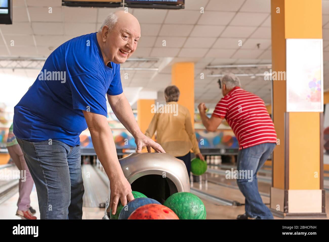 Senior people playing bowling in club Stock Photo - Alamy