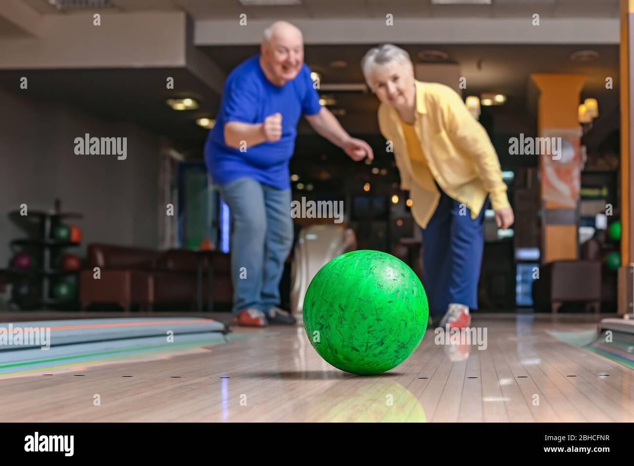 Senior people playing bowling in club Stock Photo - Alamy