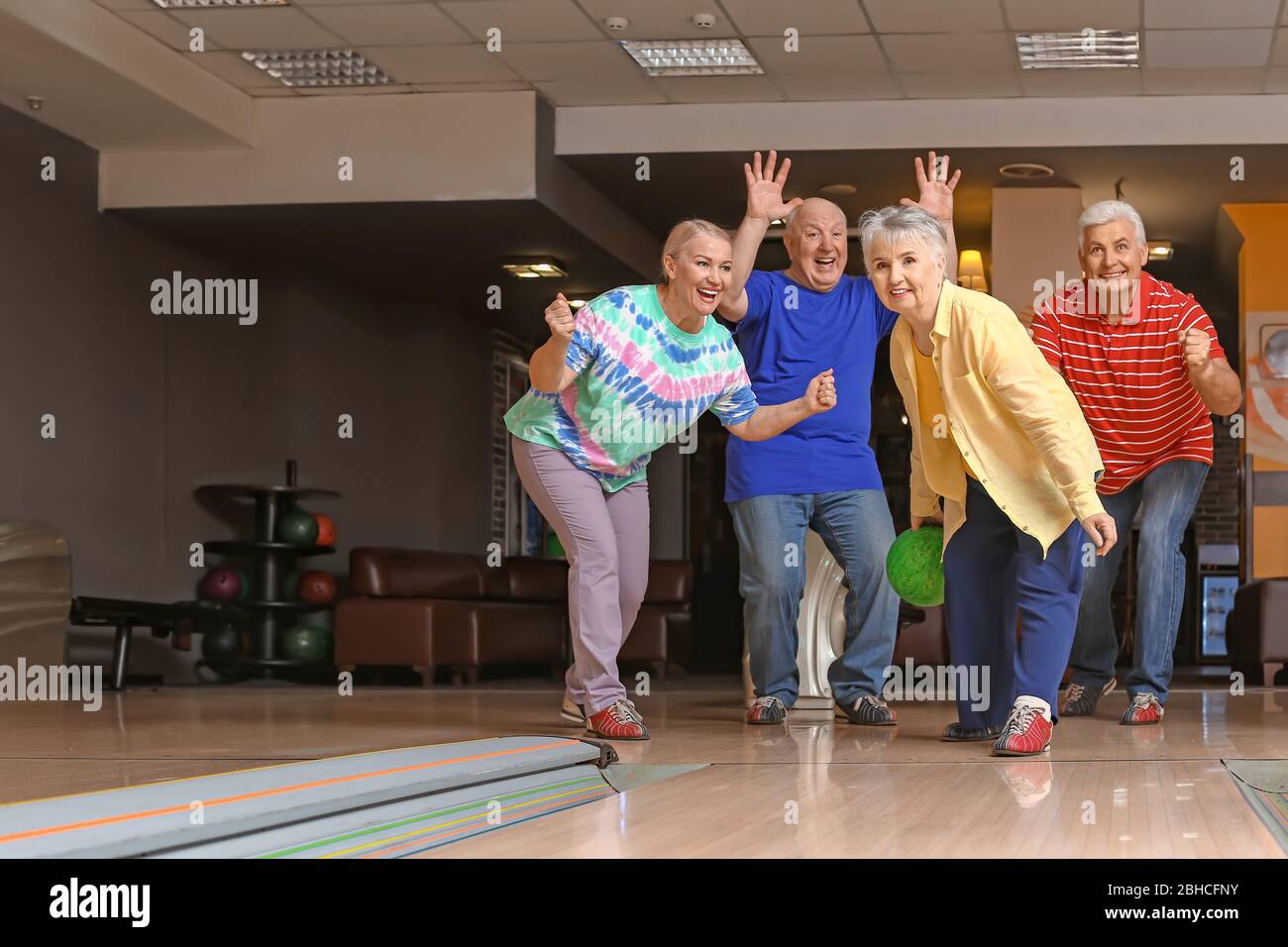 Senior people playing bowling in club Stock Photo - Alamy