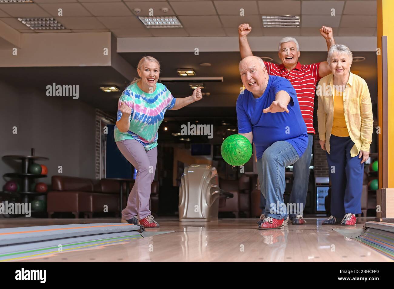 Senior people playing bowling in club Stock Photo - Alamy