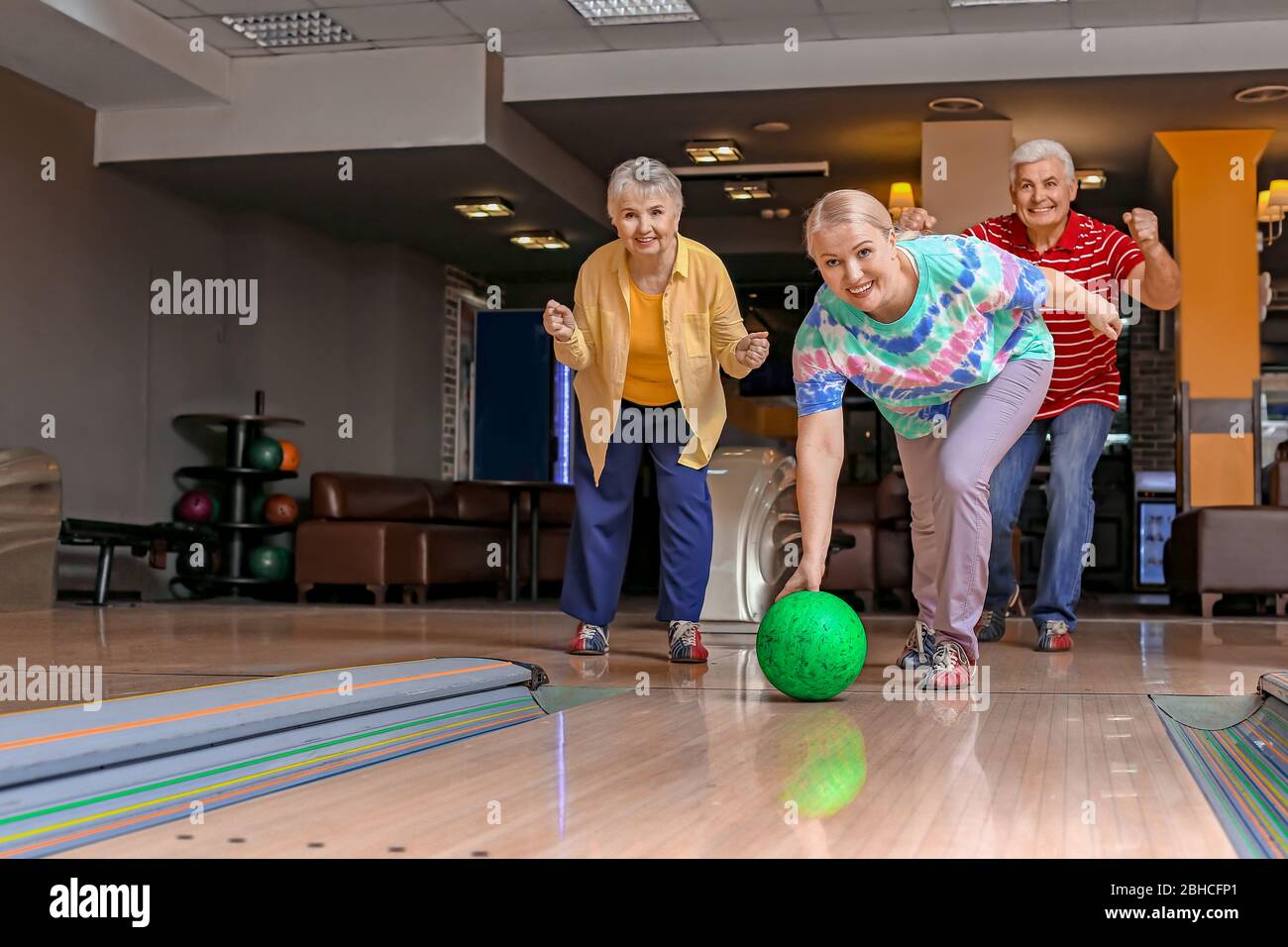 Senior people playing bowling in club Stock Photo - Alamy