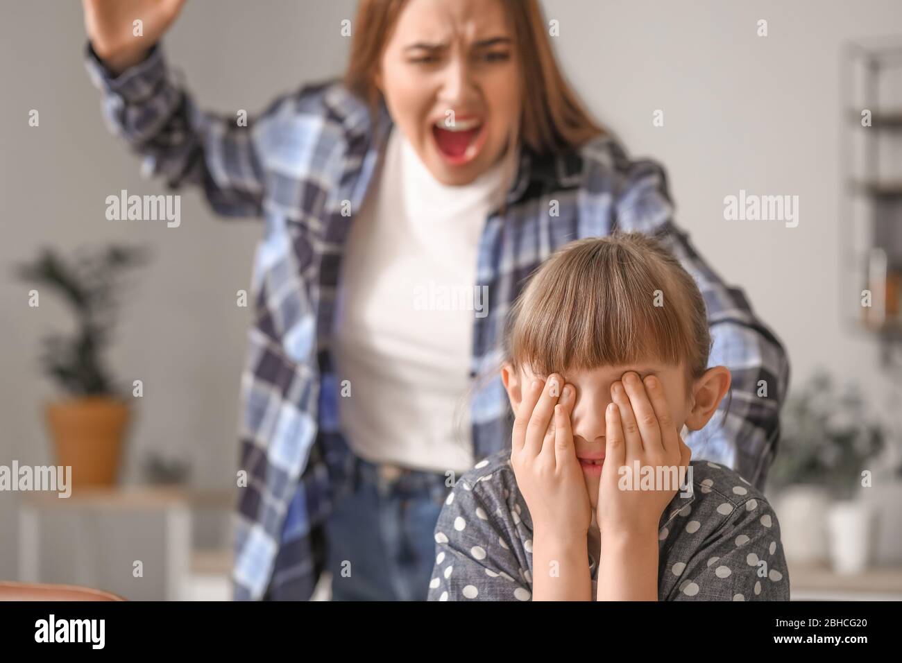 Angry mother threatening her daughter at home Stock Photo - Alamy