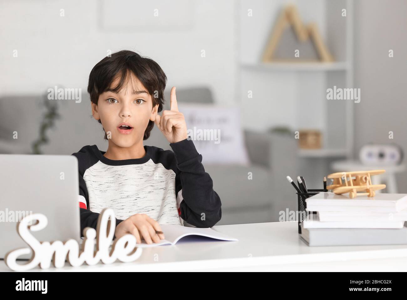 Little boy doing homework in room Stock Photo - Alamy