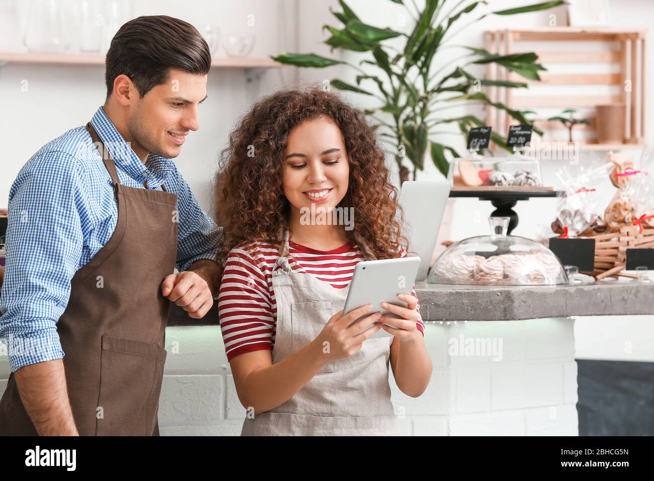 Business owners working in their cafe Stock Photo - Alamy