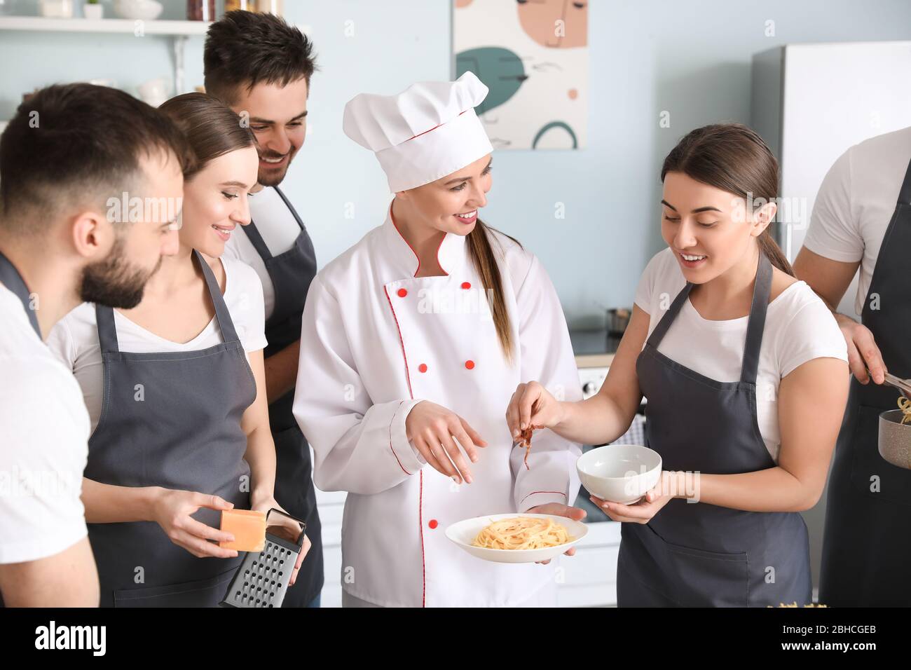 Female chef and group of young people during cooking classes Stock ...