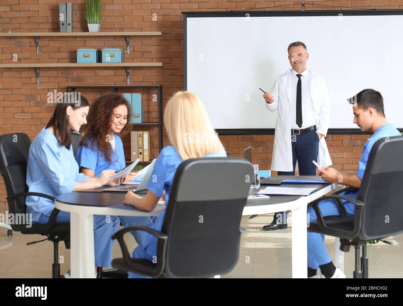 Male lecturer teaching medical students in university Stock Photo - Alamy