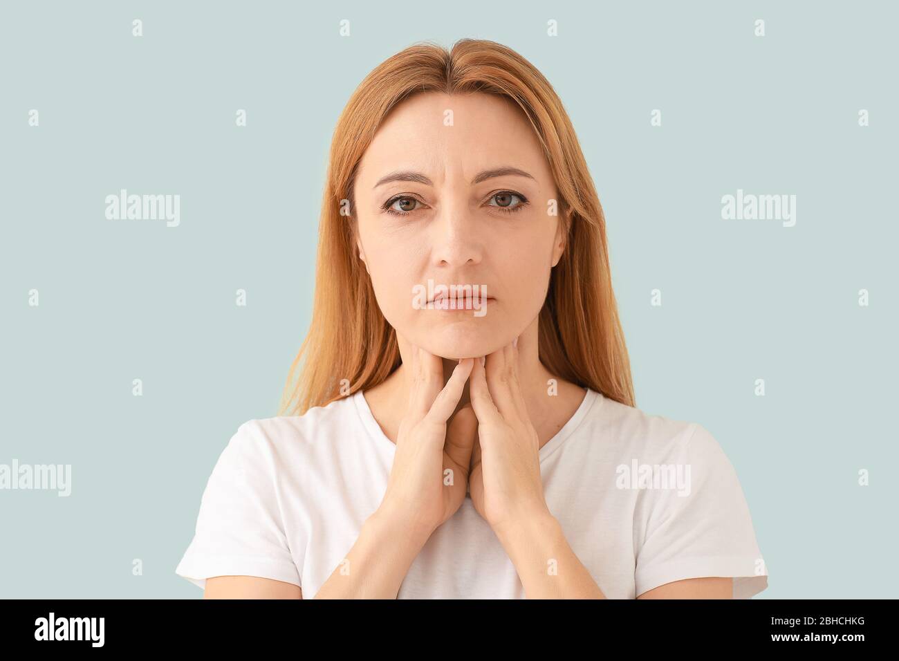 Woman with thyroid gland problem on light background Stock Photo - Alamy