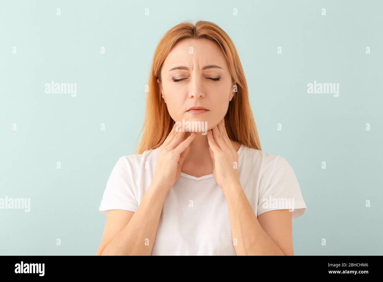 Woman with thyroid gland problem on light background Stock Photo - Alamy