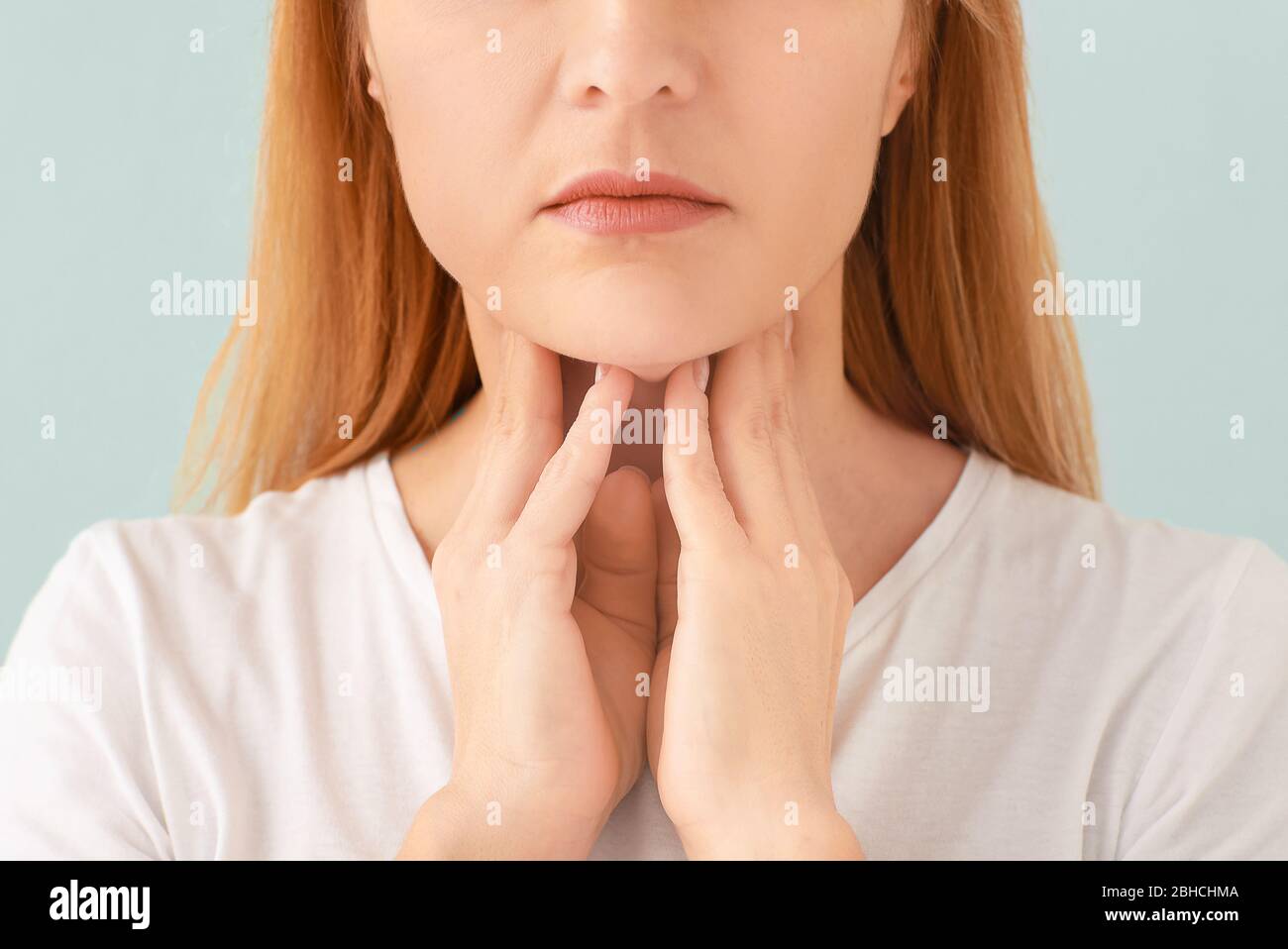 Woman with thyroid gland problem on light background Stock Photo - Alamy