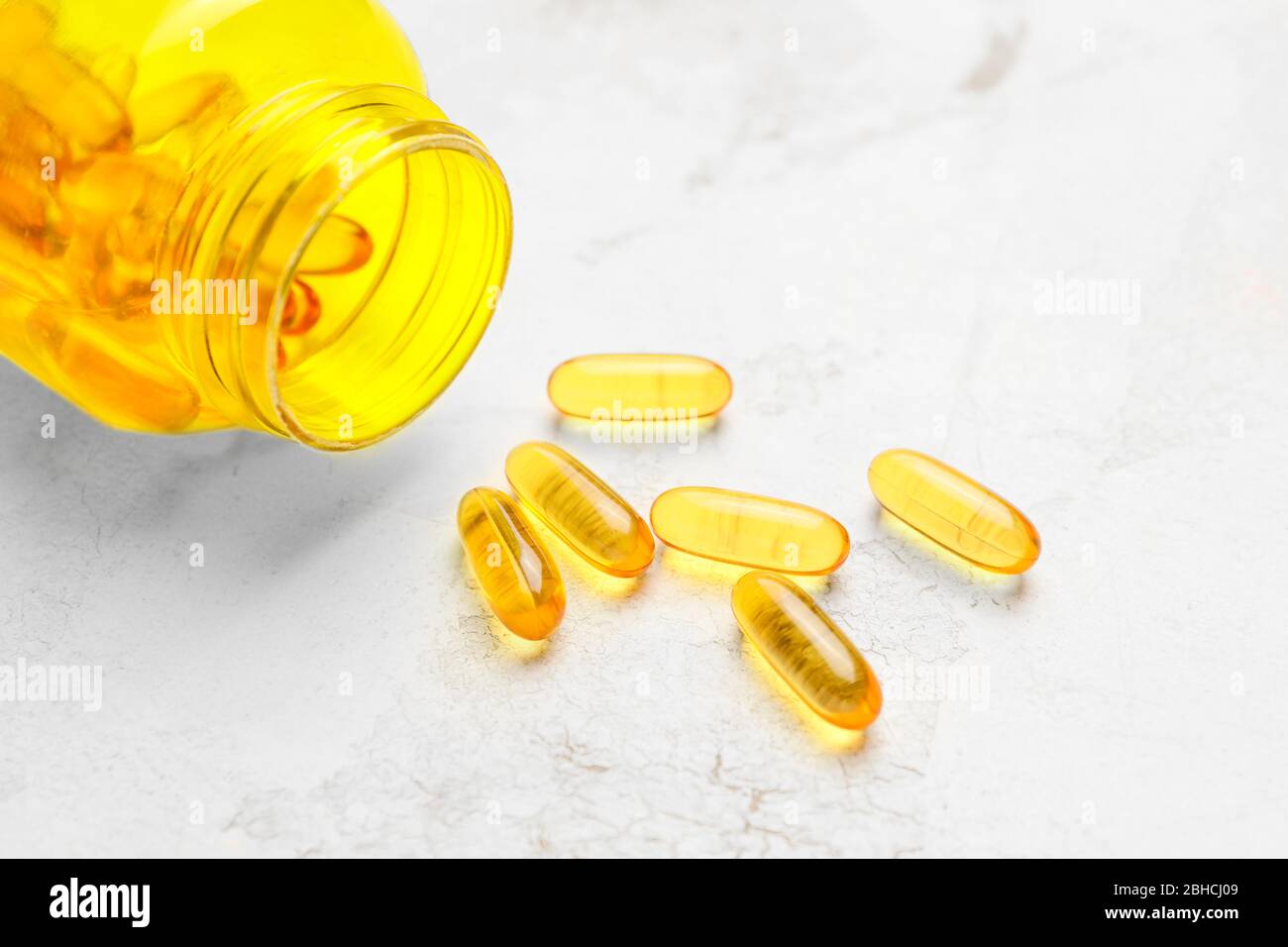 Fish fat oil capsules scattered hi-res stock photography and images - Alamy