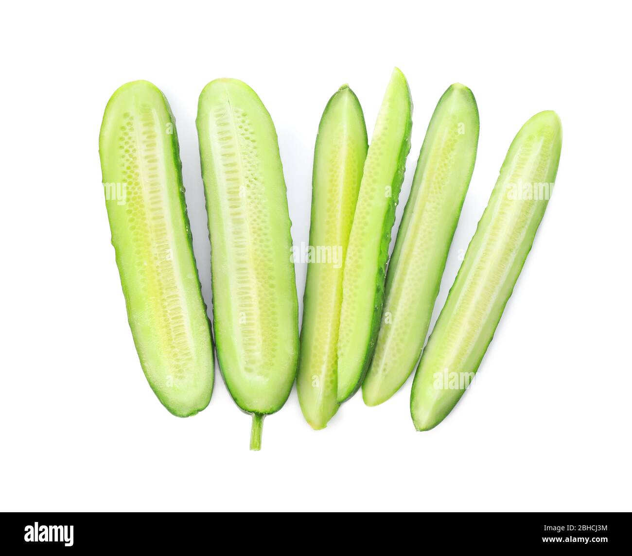 Green cut cucumbers on white background Stock Photo - Alamy