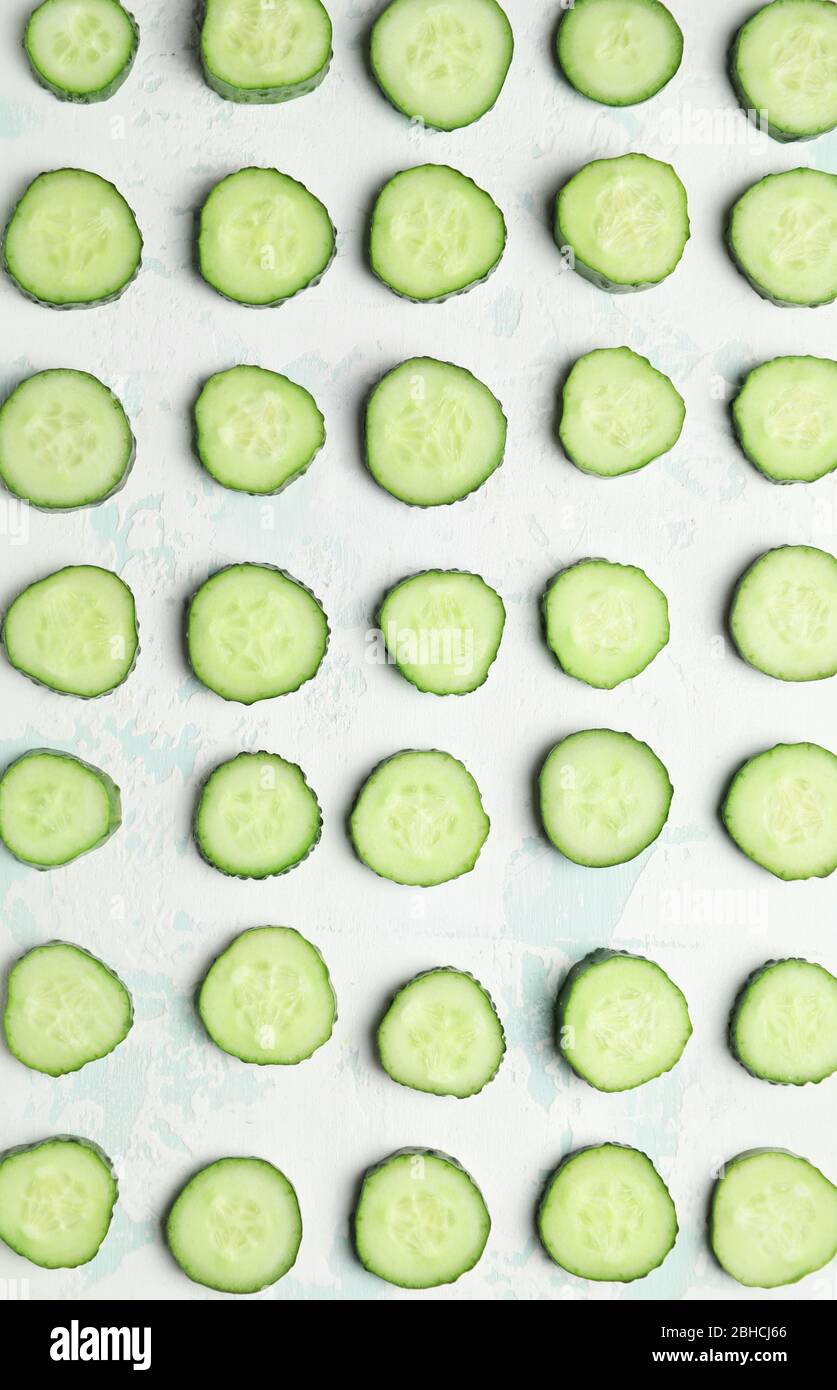 Green cut cucumbers on white background Stock Photo - Alamy