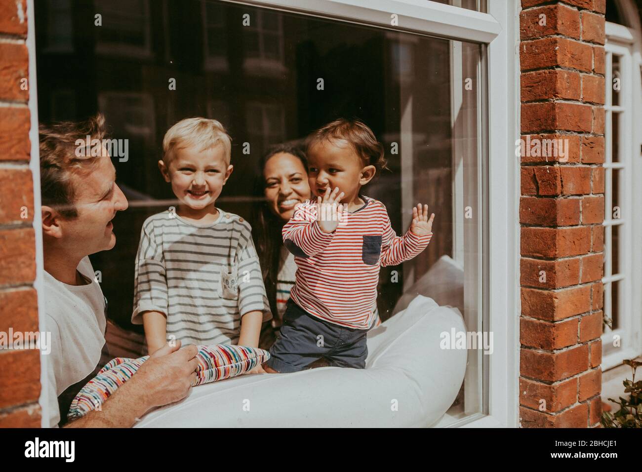 Family seen through window hi-res stock photography and images - Alamy