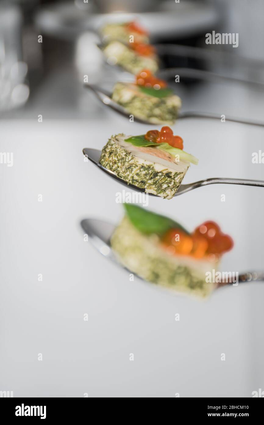 Tasty canapes plates in line hanging with caviar and cream cheese ...