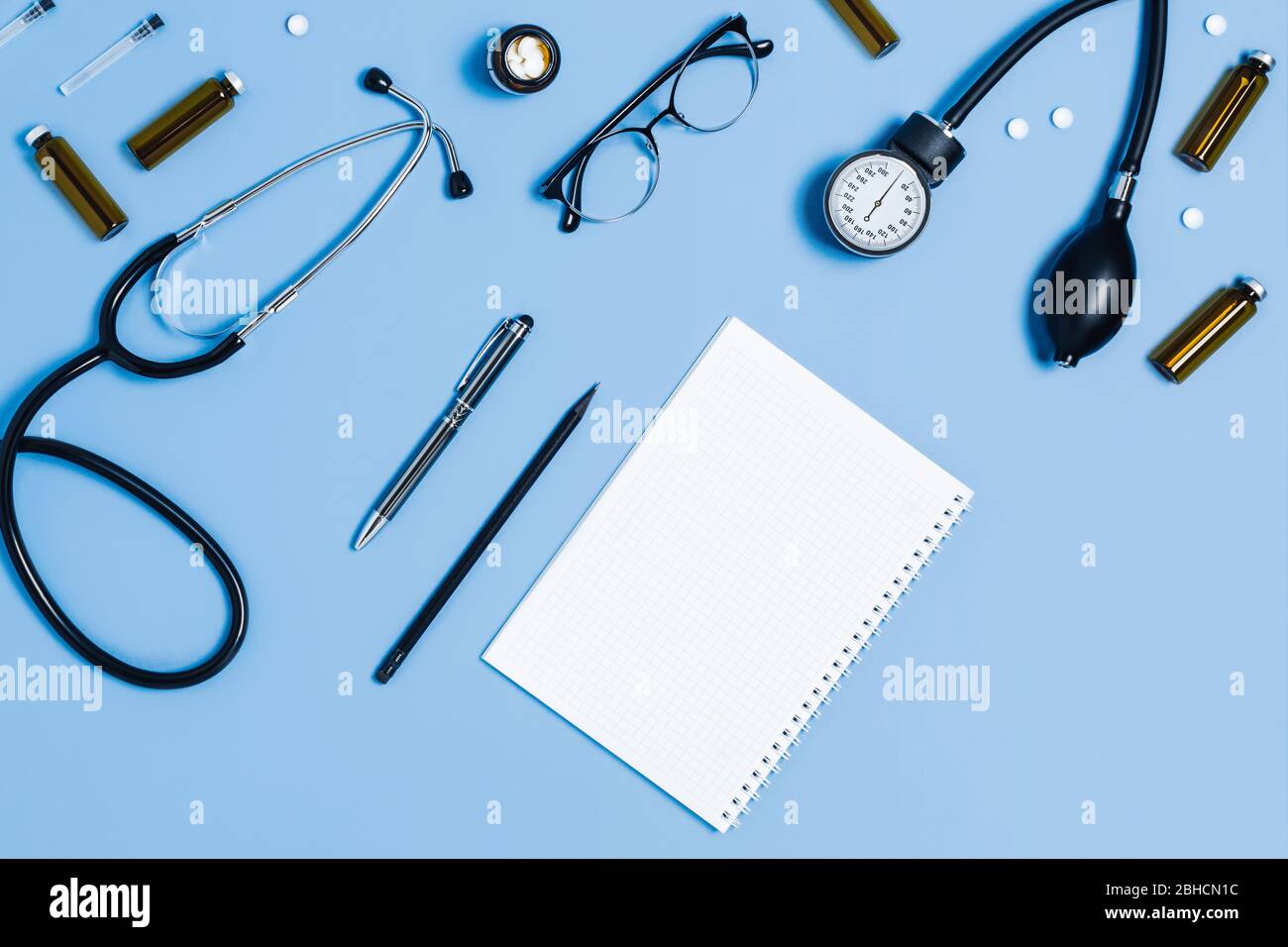 Medical blue background with different accessories: stethoscope ...